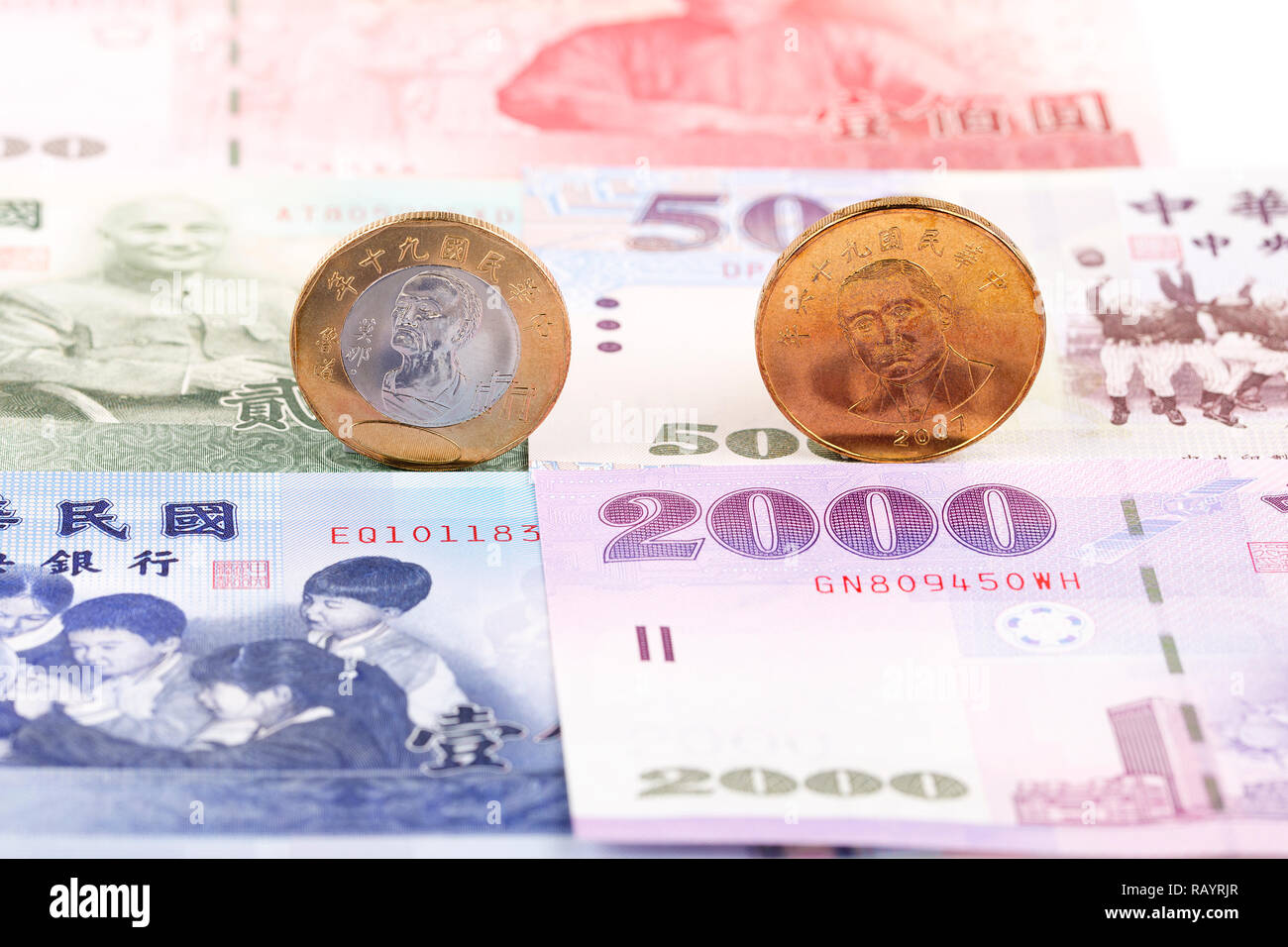 Taiwanese dollar coins on the background of banknotes Stock Photo - Alamy