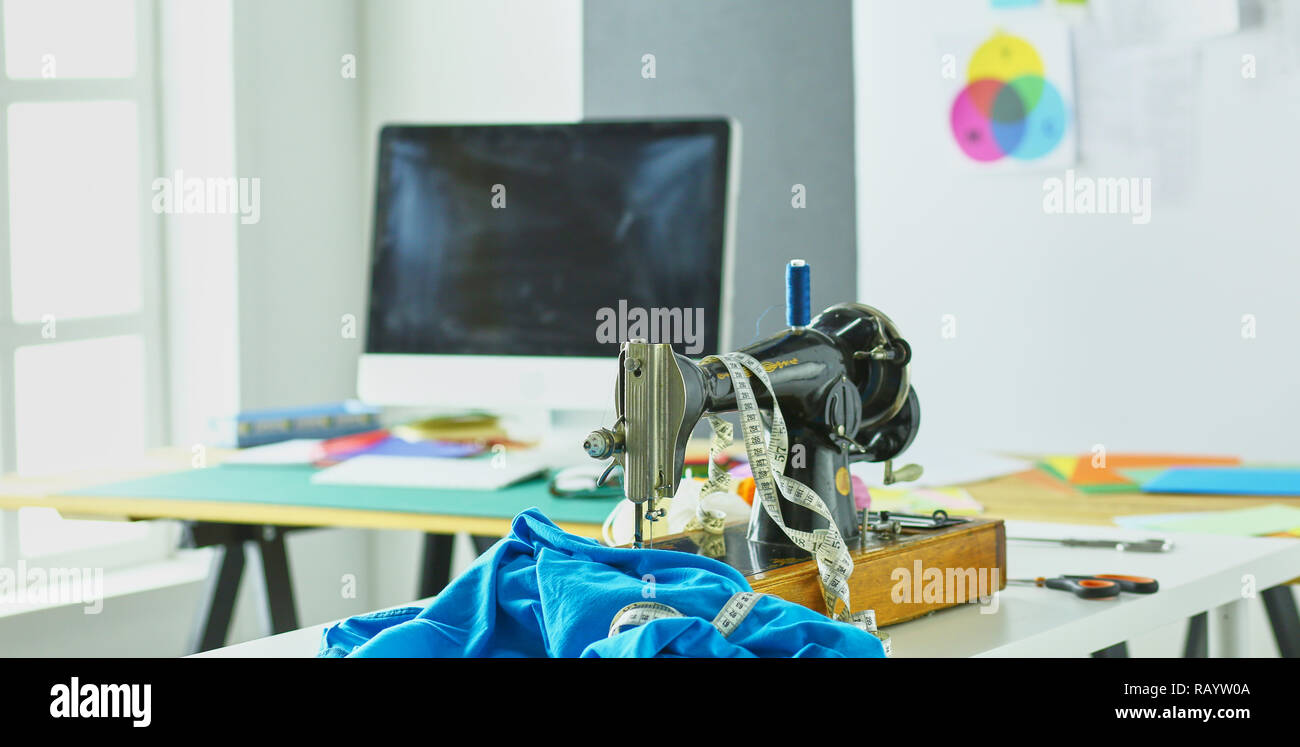 Retro sewing machine on designer clothes desktop Stock Photo - Alamy