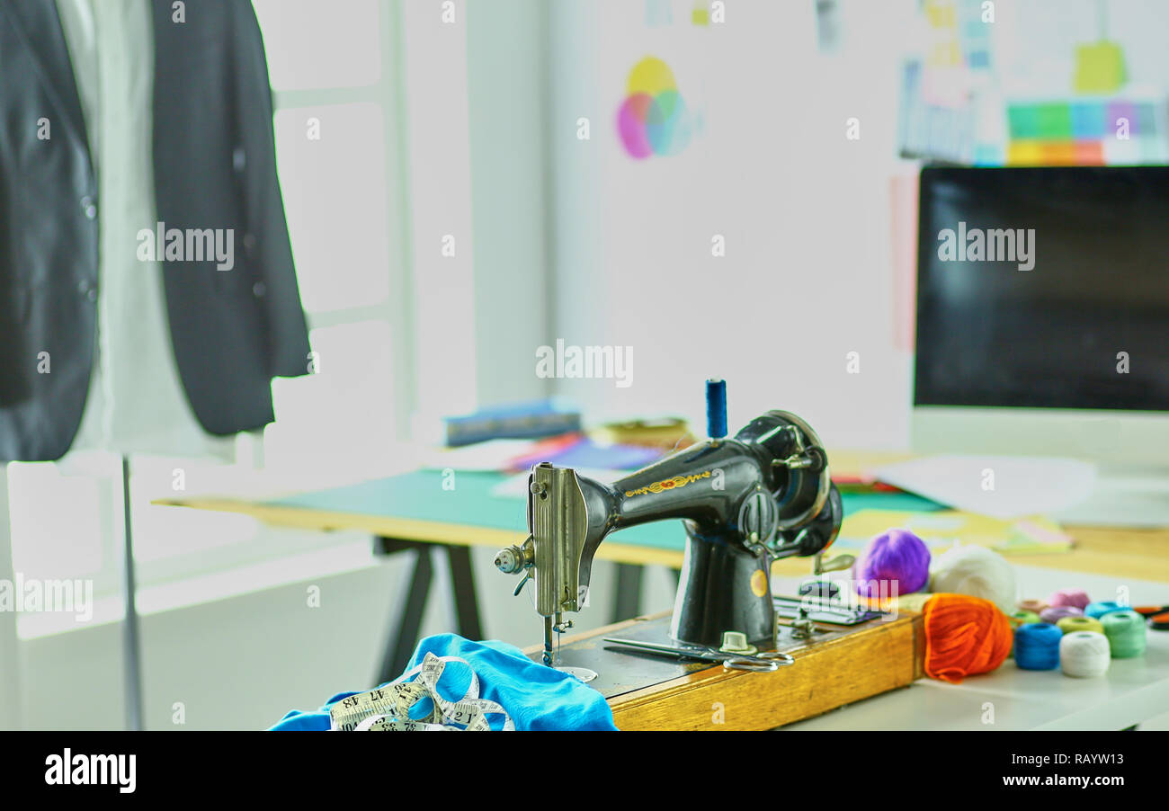 Retro sewing machine on designer clothes desktop Stock Photo - Alamy