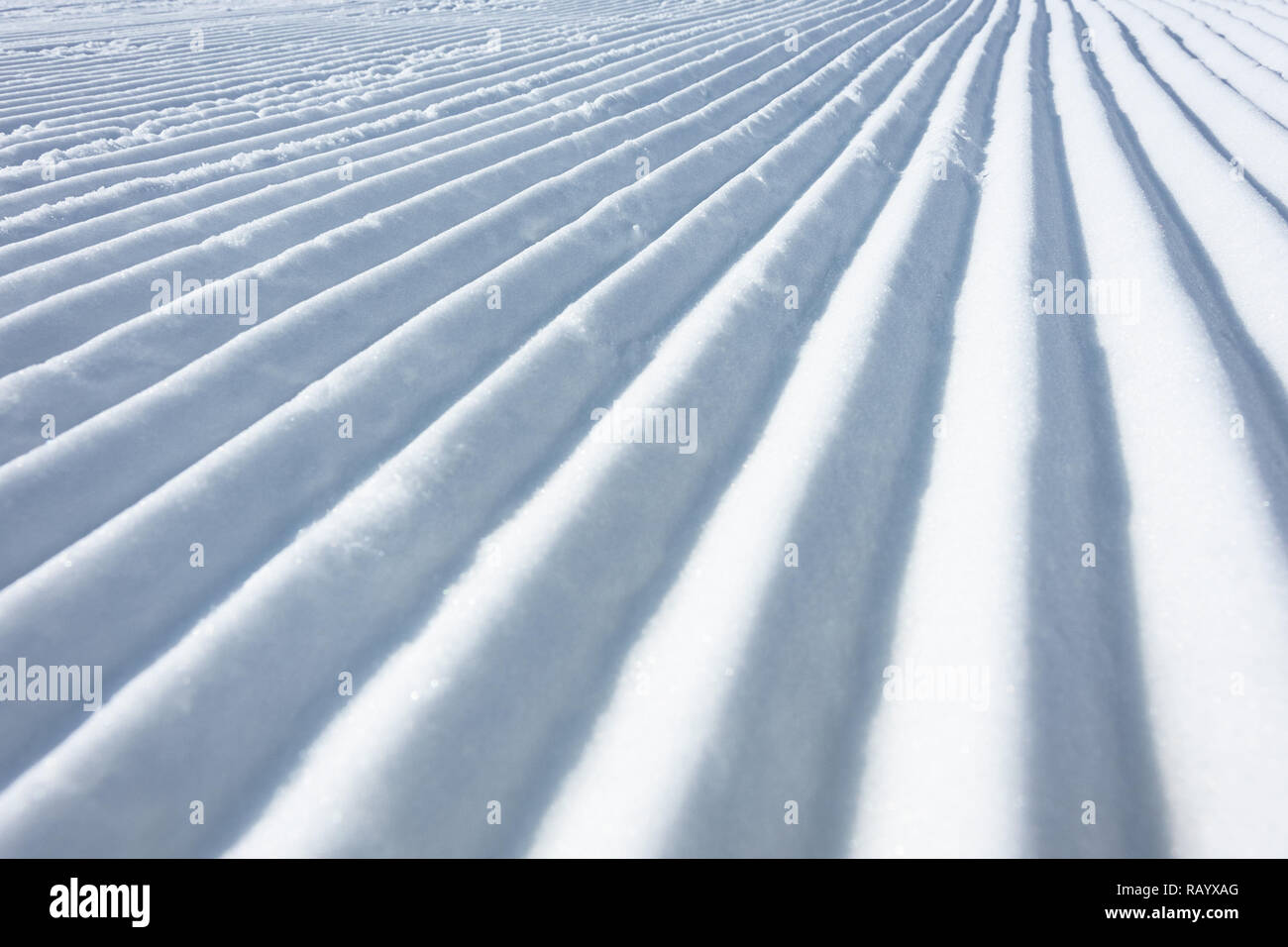 Geometry track lines on a ski slope left by a snowcat as a texture ...