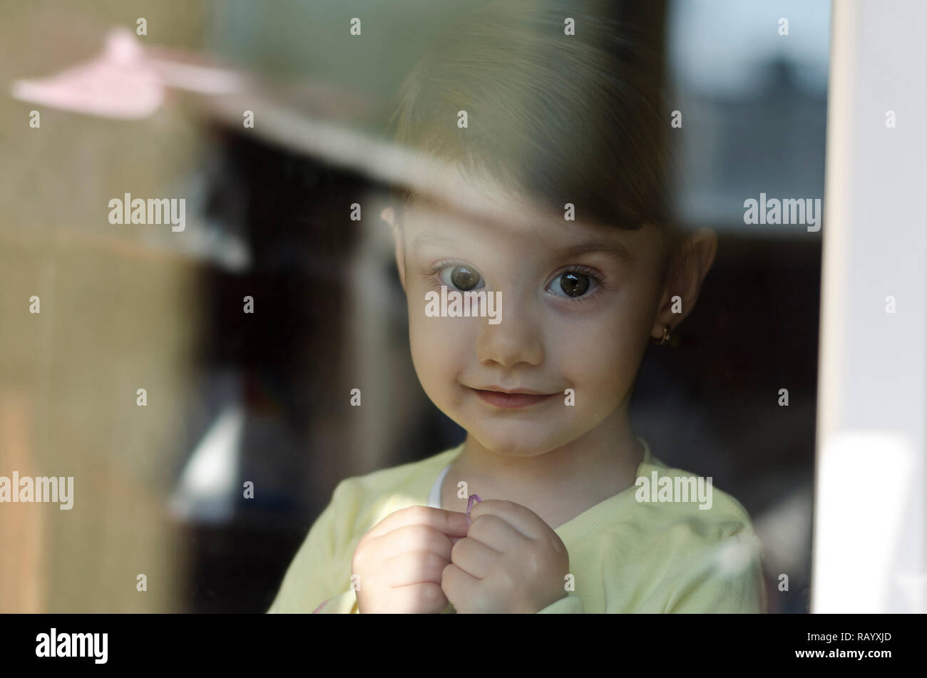 A cute little girl looking at you Stock Photo - Alamy