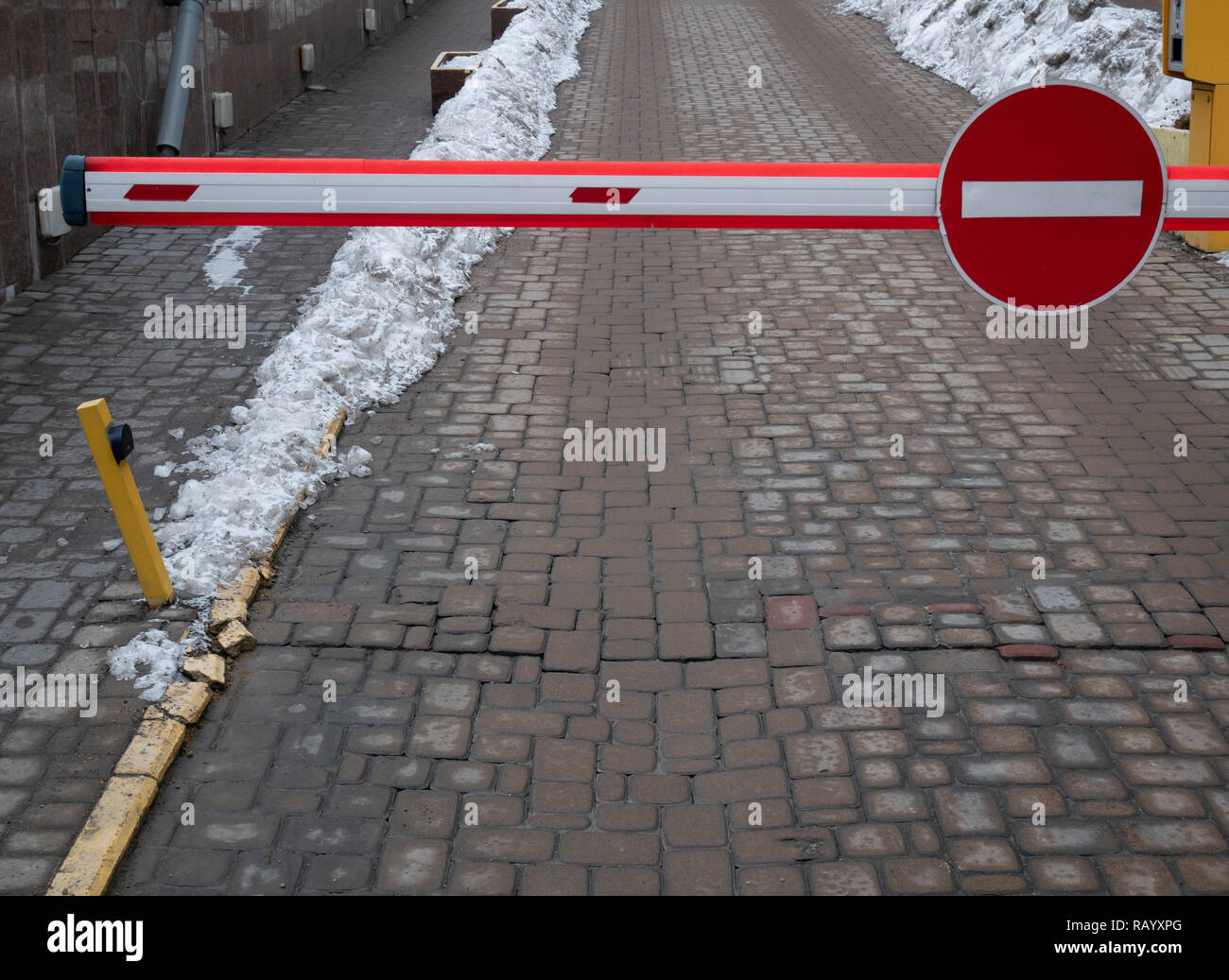 wide photo of automatic car parking gate barrier with no entry sign ...
