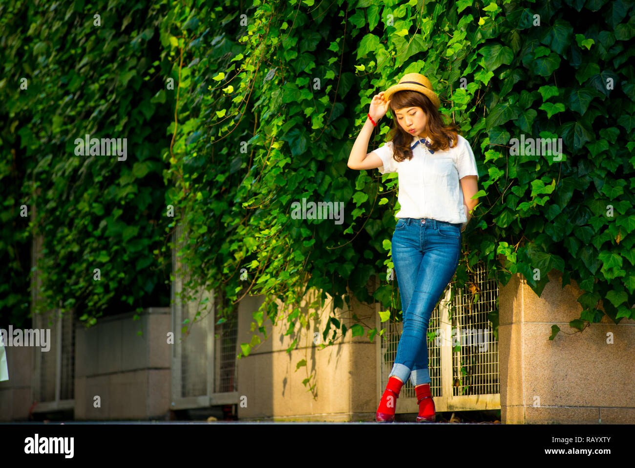 Asian female model poses for pictures on the street Stock Photo - Alamy