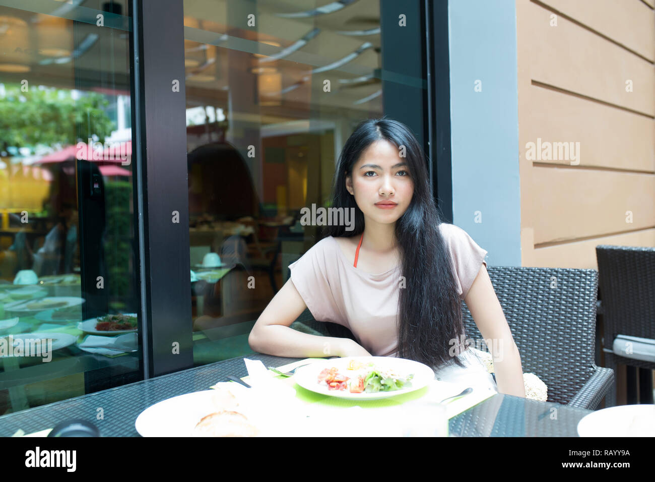Pretty asian woman having meal in the restaurant Stock Photo - Alamy