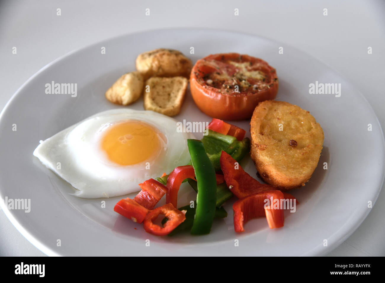 Breakfast with scrambled eggs, fried buns and vegetables Stock Photo ...