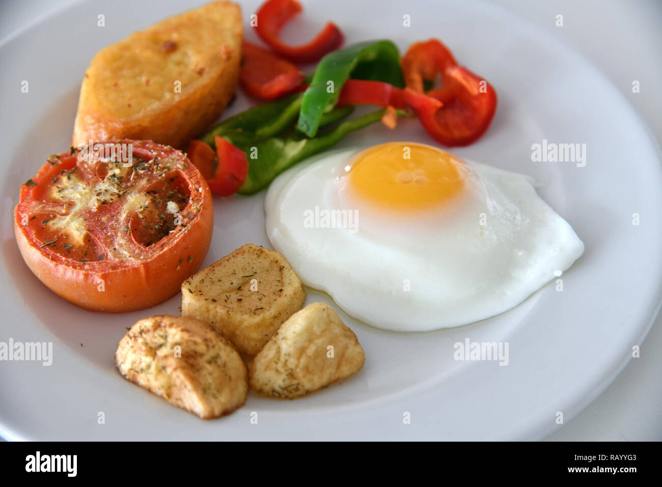 Breakfast with scrambled eggs, fried buns and vegetables Stock Photo ...
