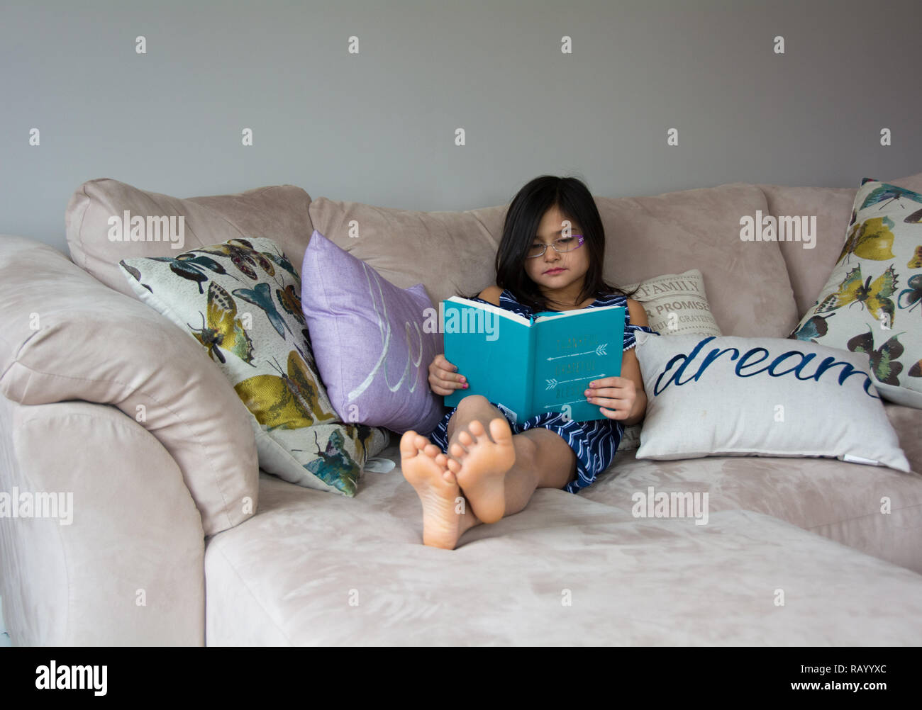 Child reading a journal Stock Photo - Alamy