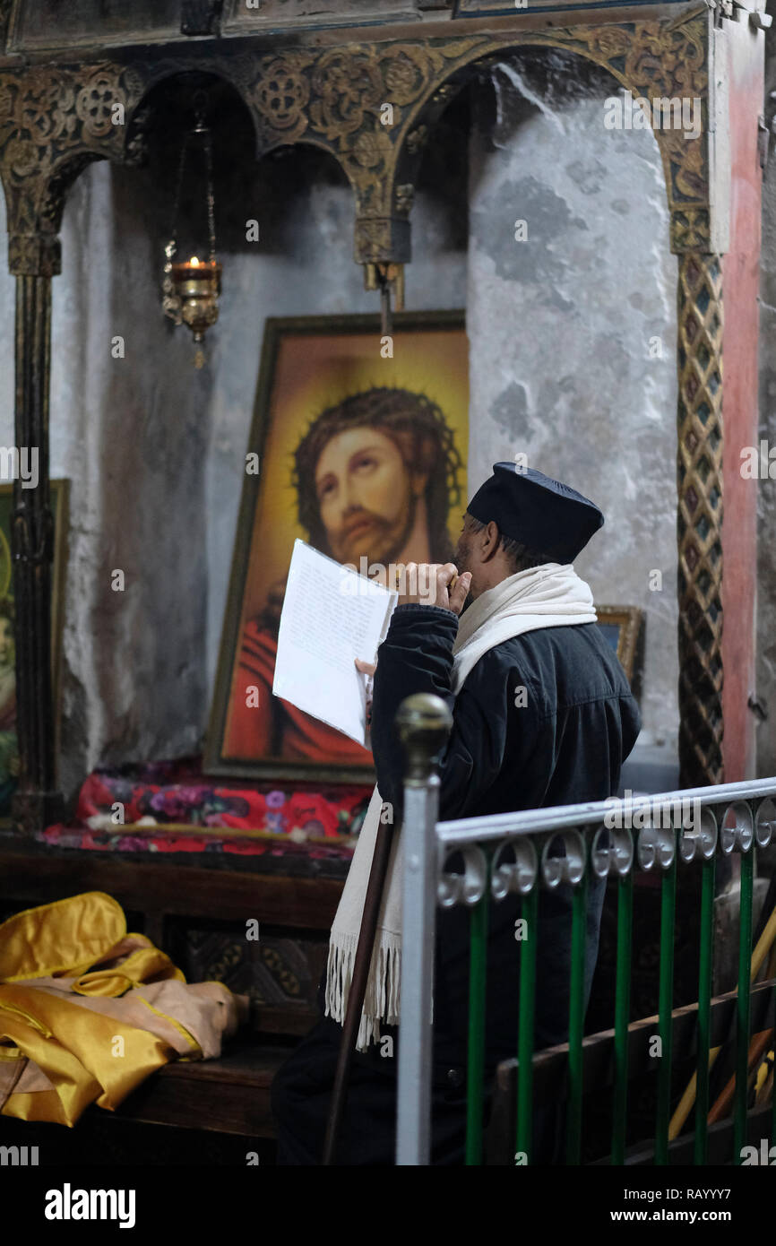 Ethiopian Orthodox monk praying inside the Coptic Chapel of St. Michael ...