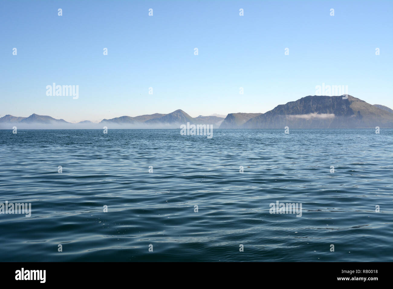 Mist hangs over the Bering Sea coast of Unalaska Island, in the ...