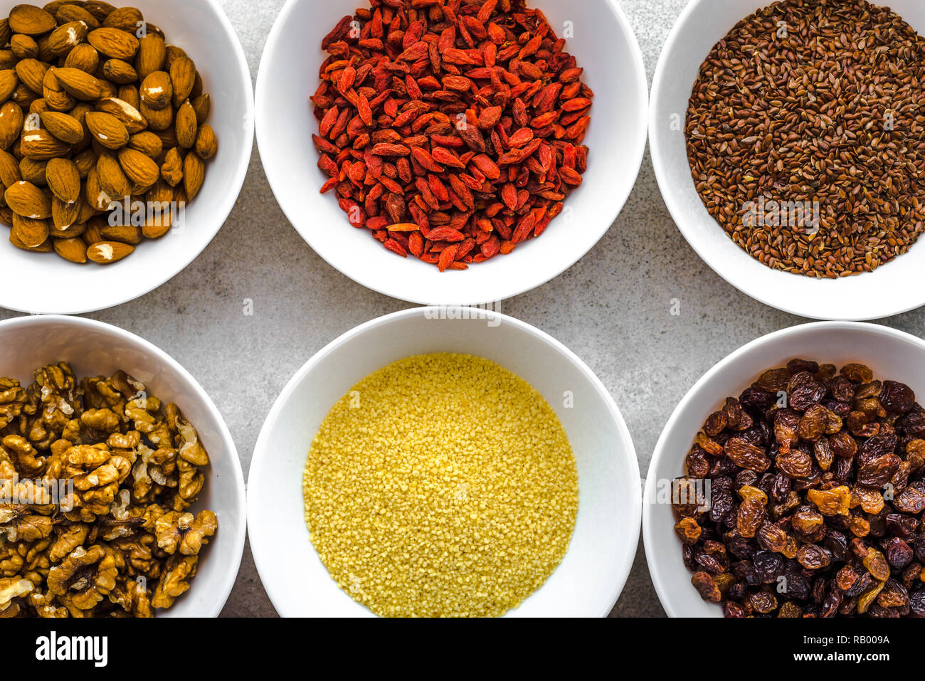 Ingredients of healthy breakfast with superfood on table, seeds, fruits ...
