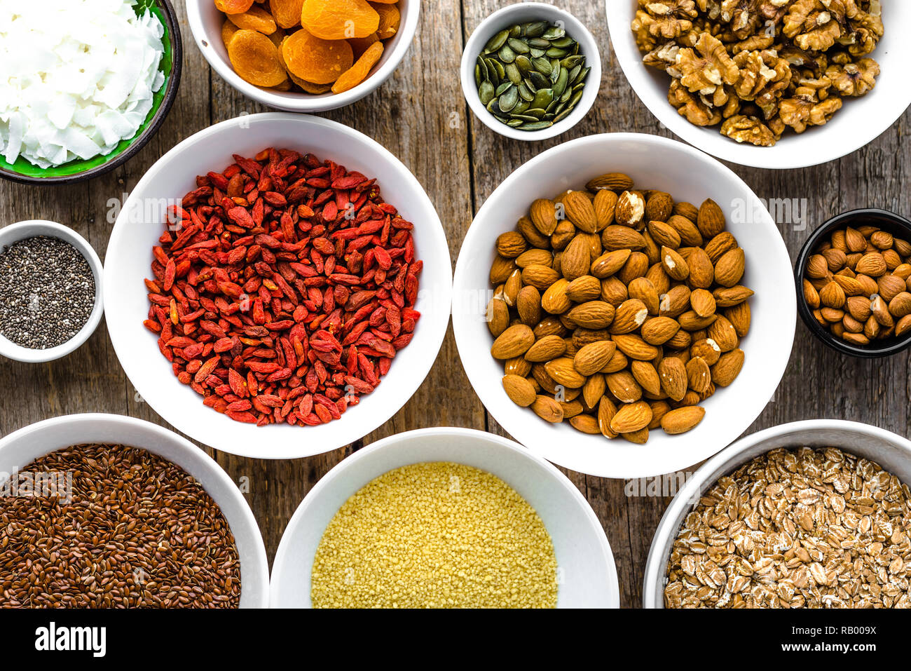 Vegetarian breakfast with healthy food selection, nuts, seeds, goji ...