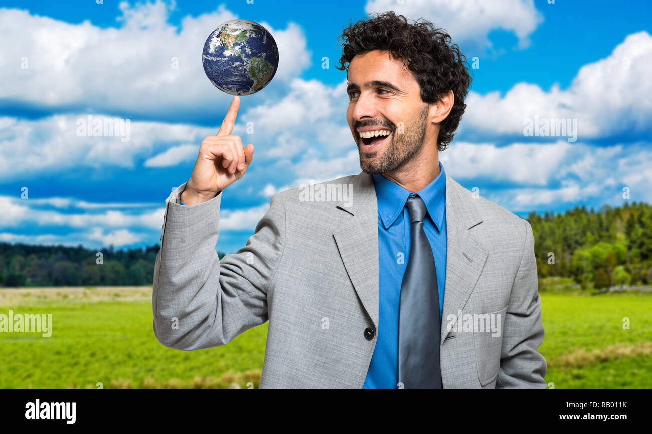 Manager holding the planet on his finger Stock Photo - Alamy