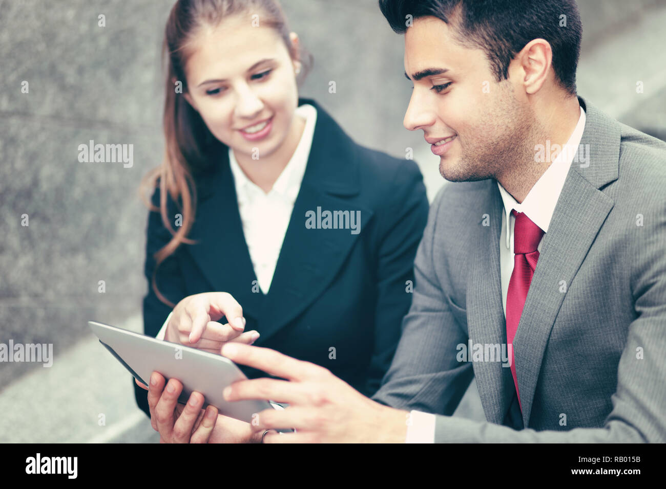 Business people using a digital tablet outdoor Stock Photo - Alamy