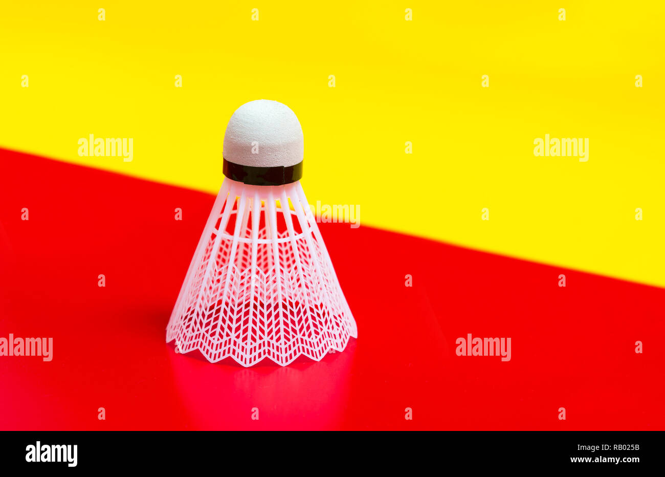 Badminton shuttlecock isolated on the red and yellow background Stock ...