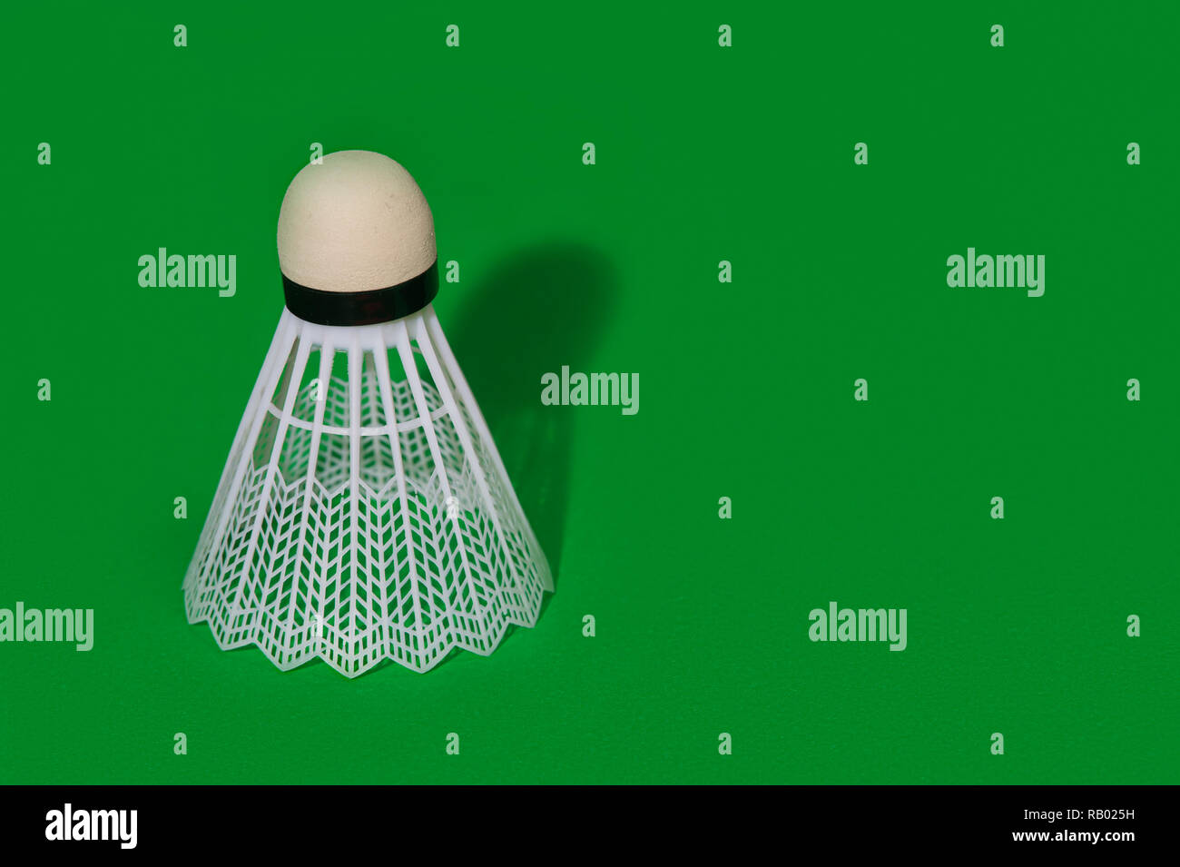 Badminton shuttlecock isolated on the green background Stock Photo - Alamy