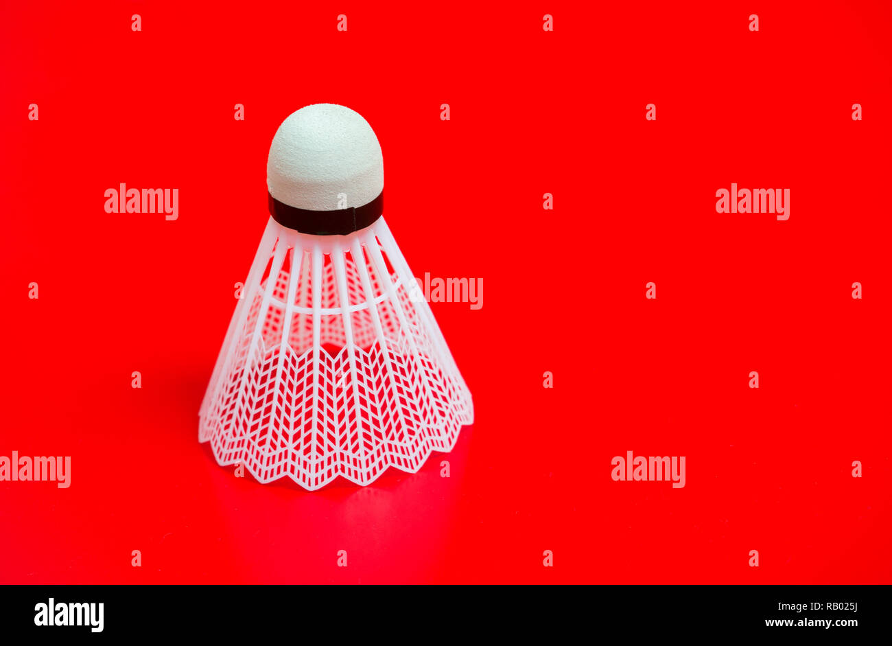 Shuttlecock in the lower right corner, on red background. copy space ...