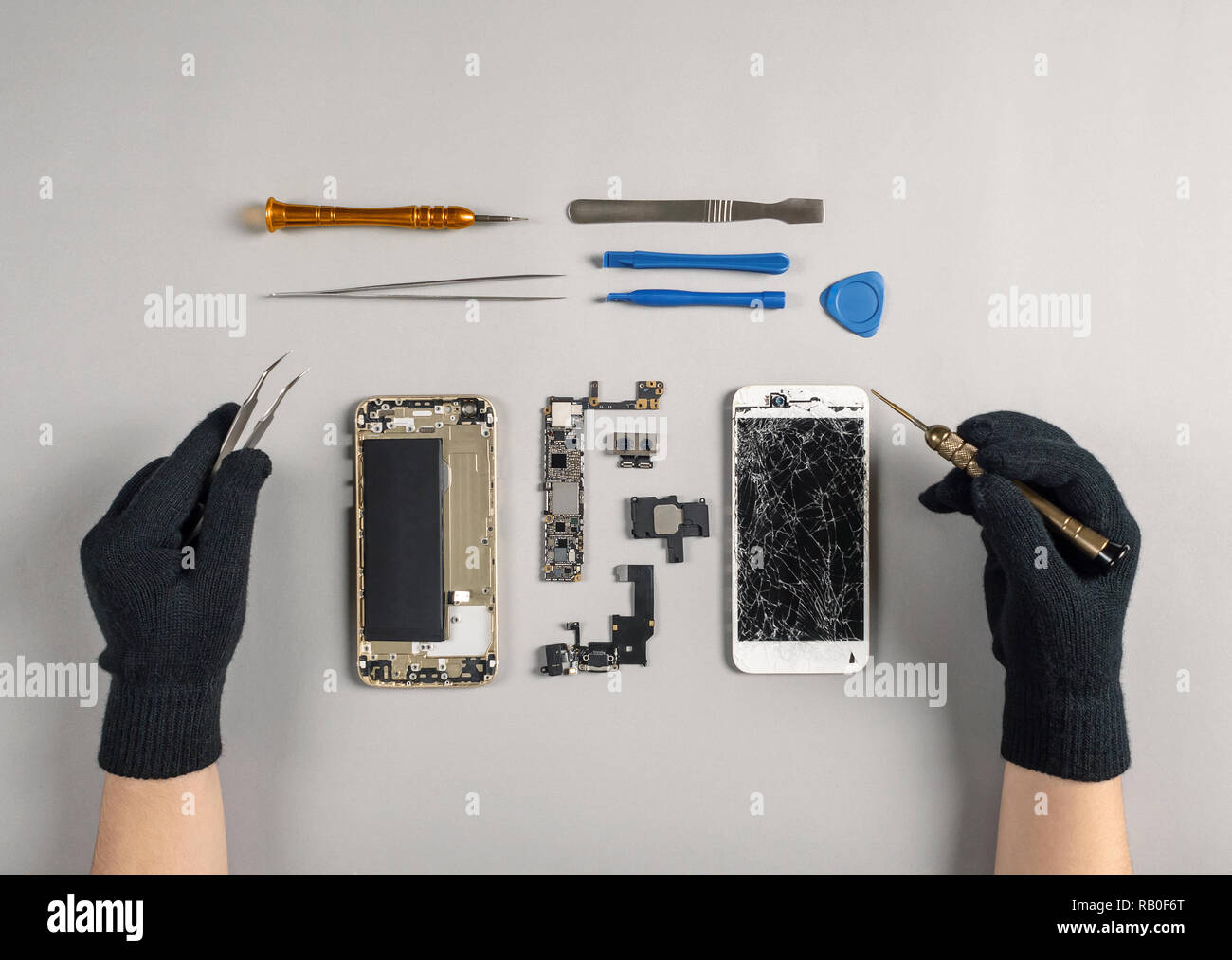 Technician or engineer disassembling components broken smartphone for ...
