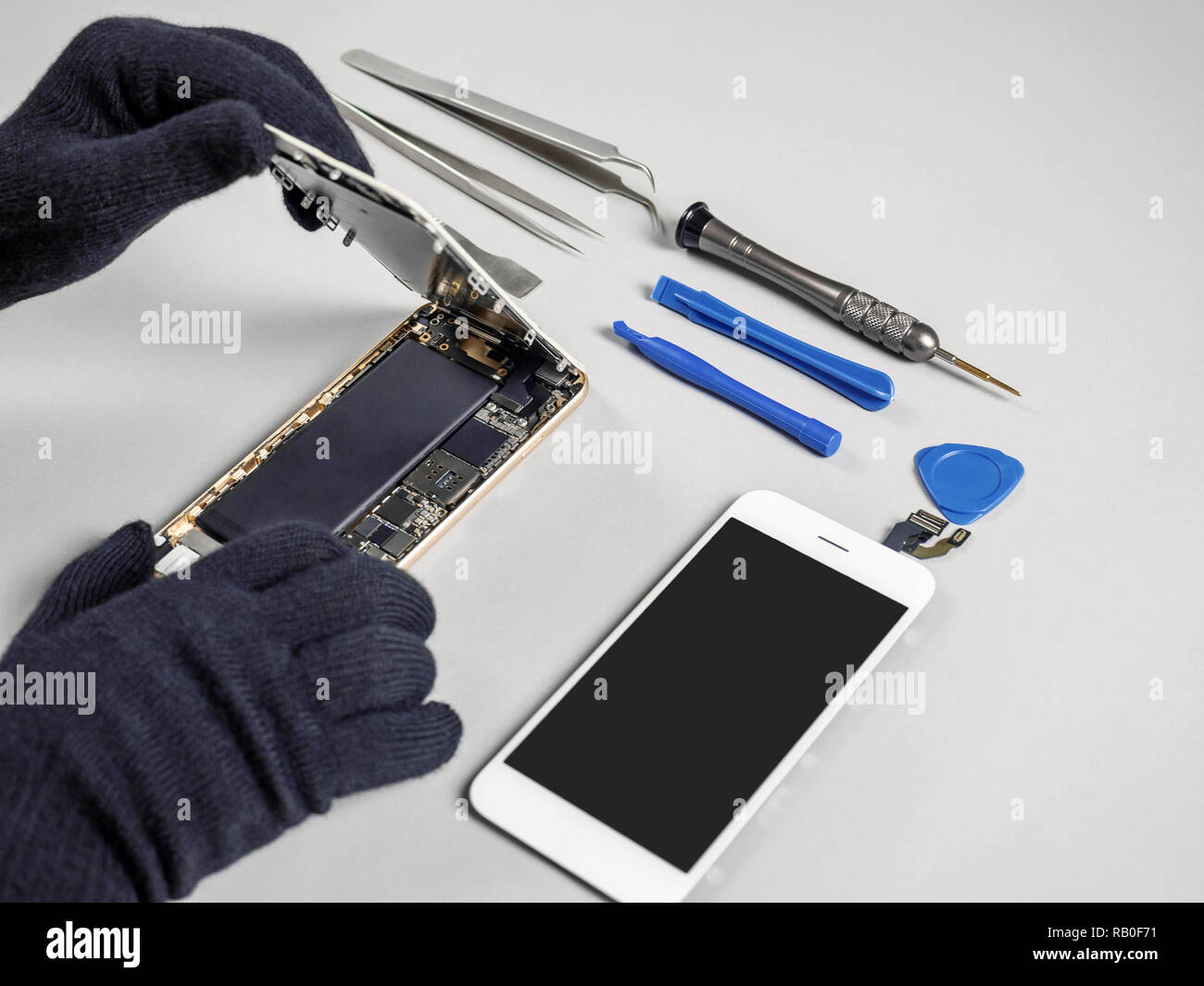 Technician or engineer disassembling components broken smartphone for ...