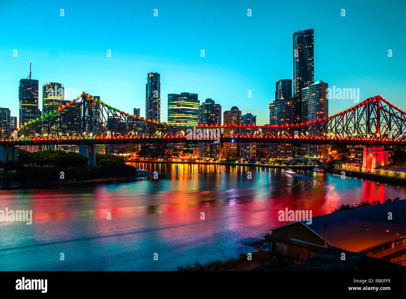 Colourful skyline of Brisbane by night with illuminated Story Bridge ...
