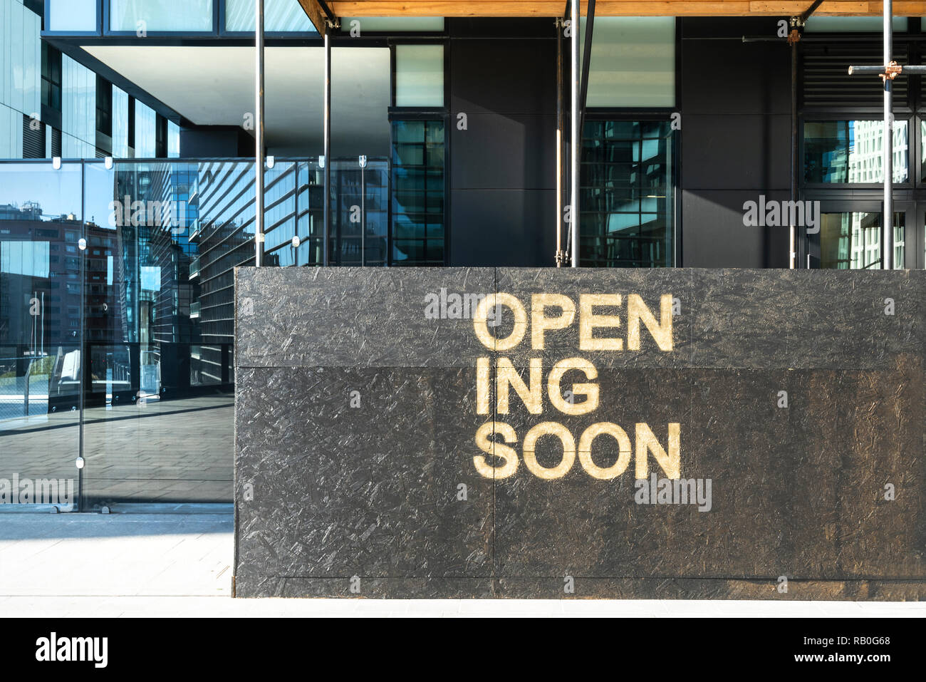 the writing Opening Soon in a building site in Milan, Italy Stock Photo ...
