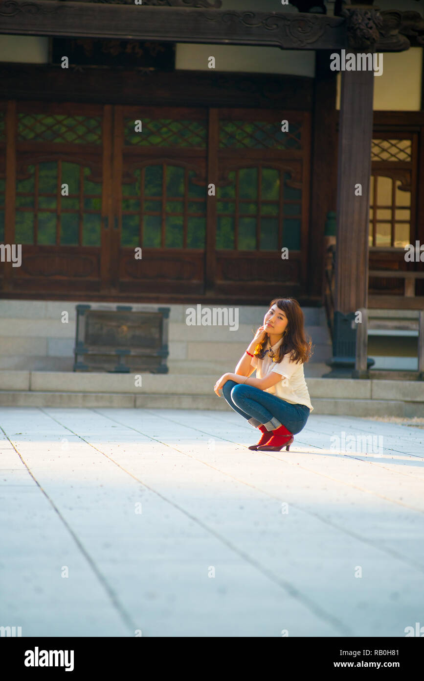 Asian female model poses for pictures on the street Stock Photo - Alamy