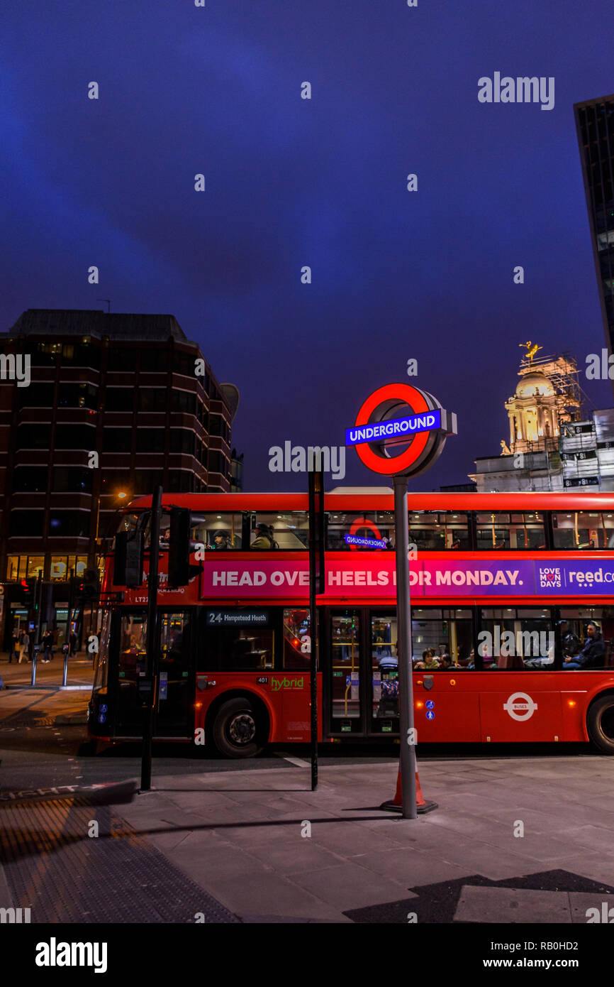 Double Decker bus stopped in front of London Underground sign Stock ...
