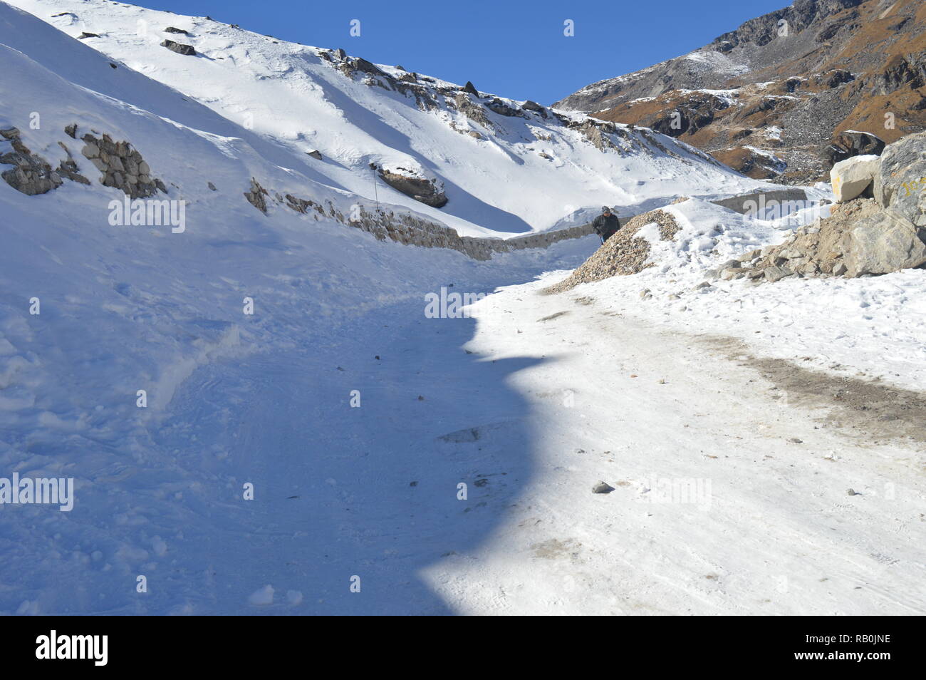 chain of snow covered mountains with blue sky on the background Stock ...