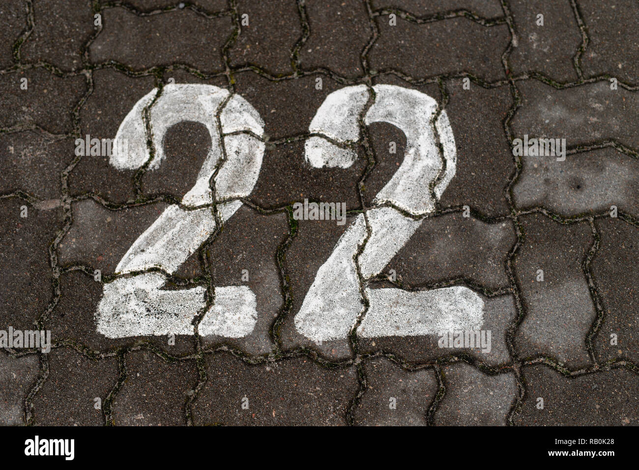 Parking space number painted on a paving stone. Parking signs for ...