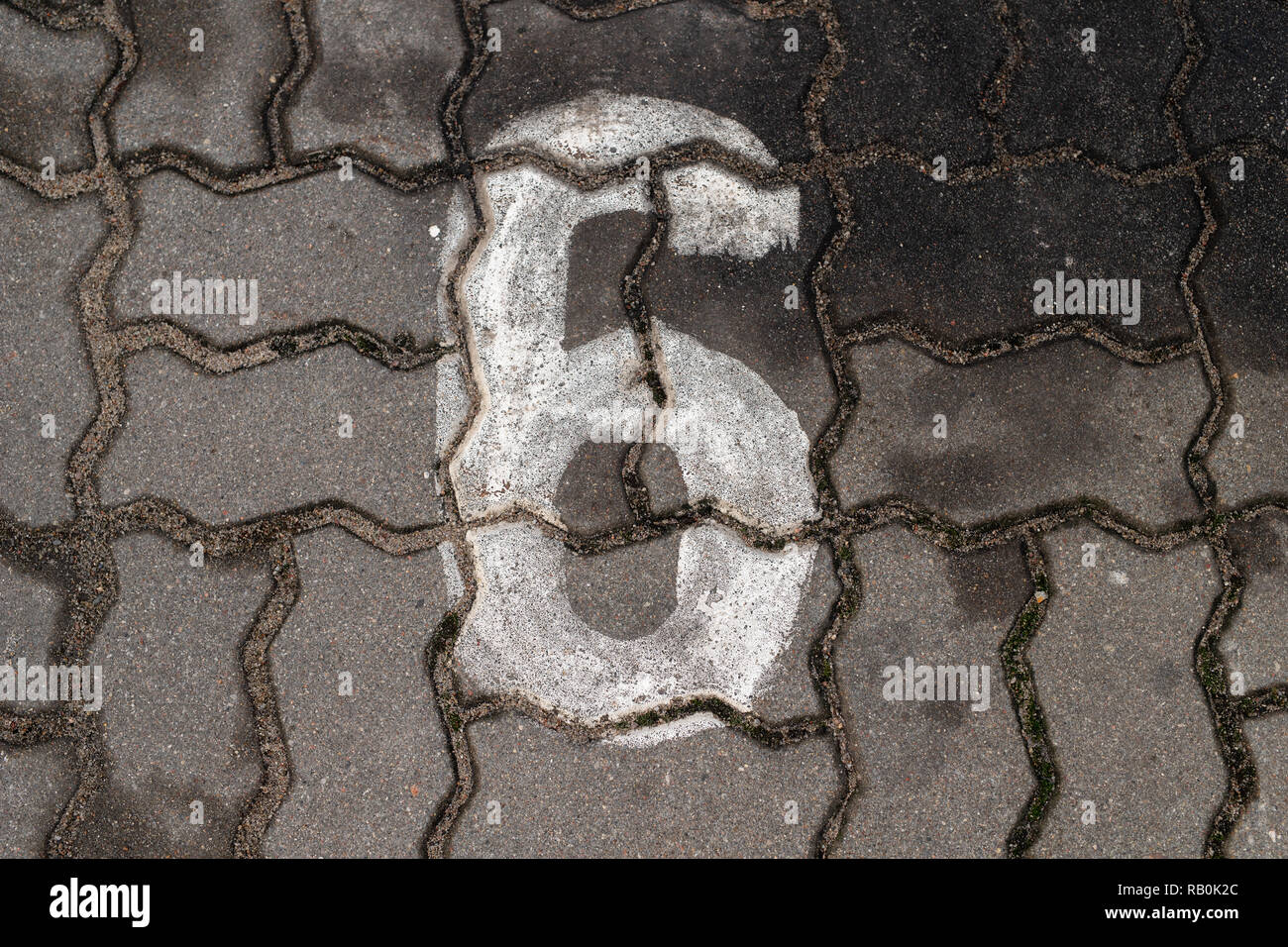 Parking space number painted on a paving stone. Parking signs for ...