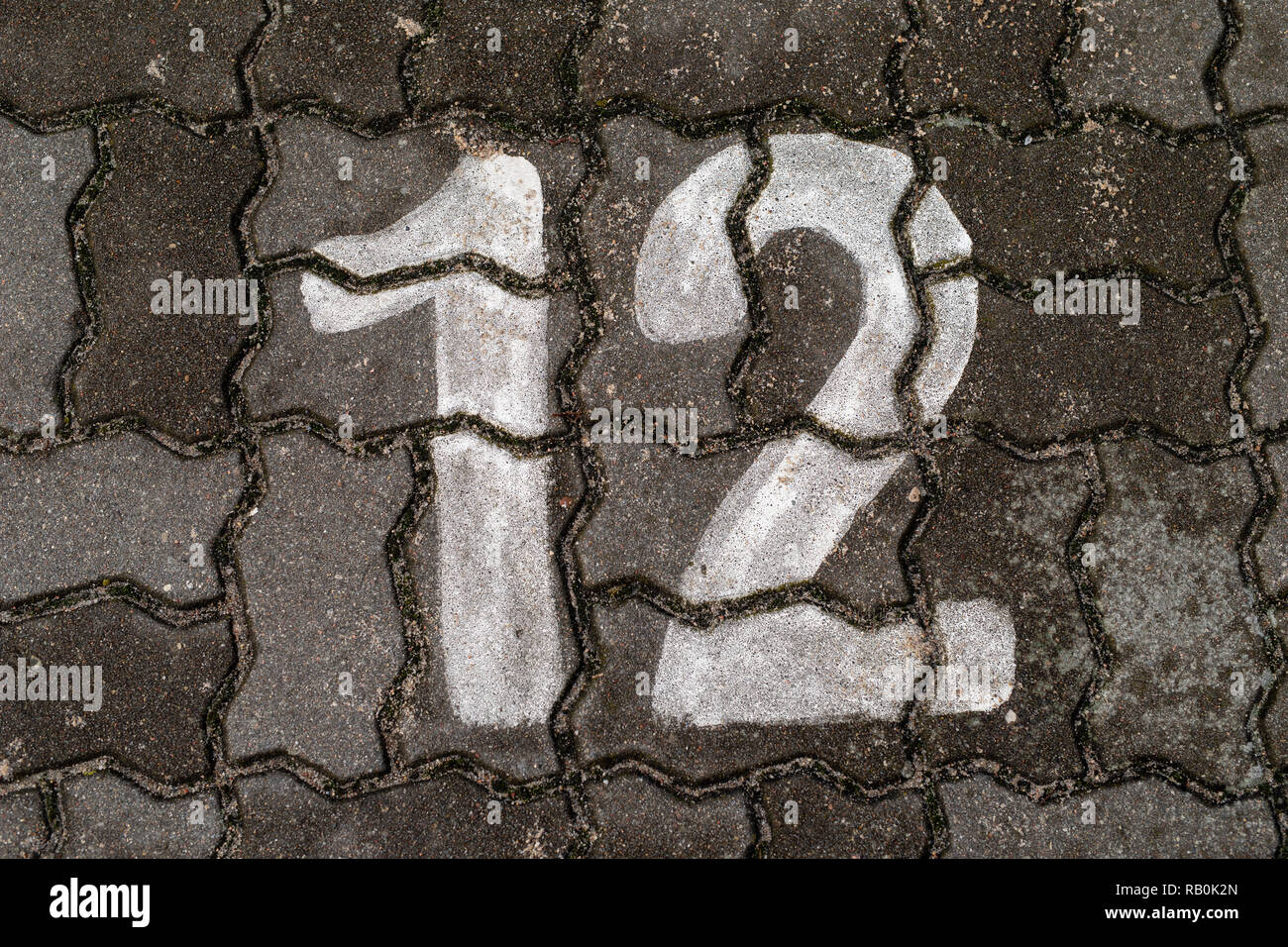 Parking space number painted on a paving stone. Parking signs for ...