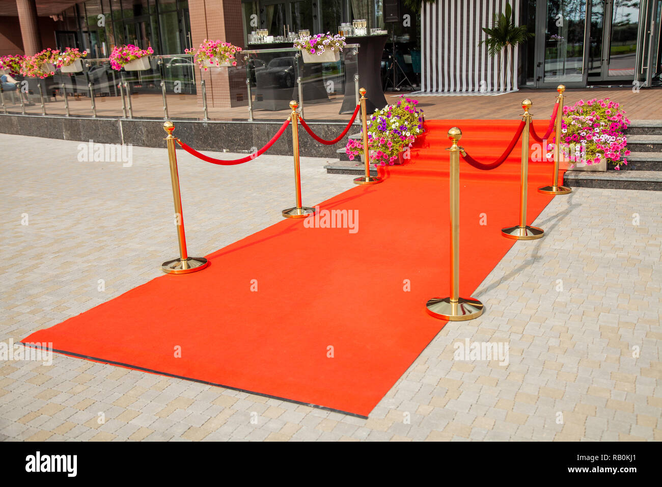 Red carpet with a gold fence entrance to the restaurant Stock Photo - Alamy