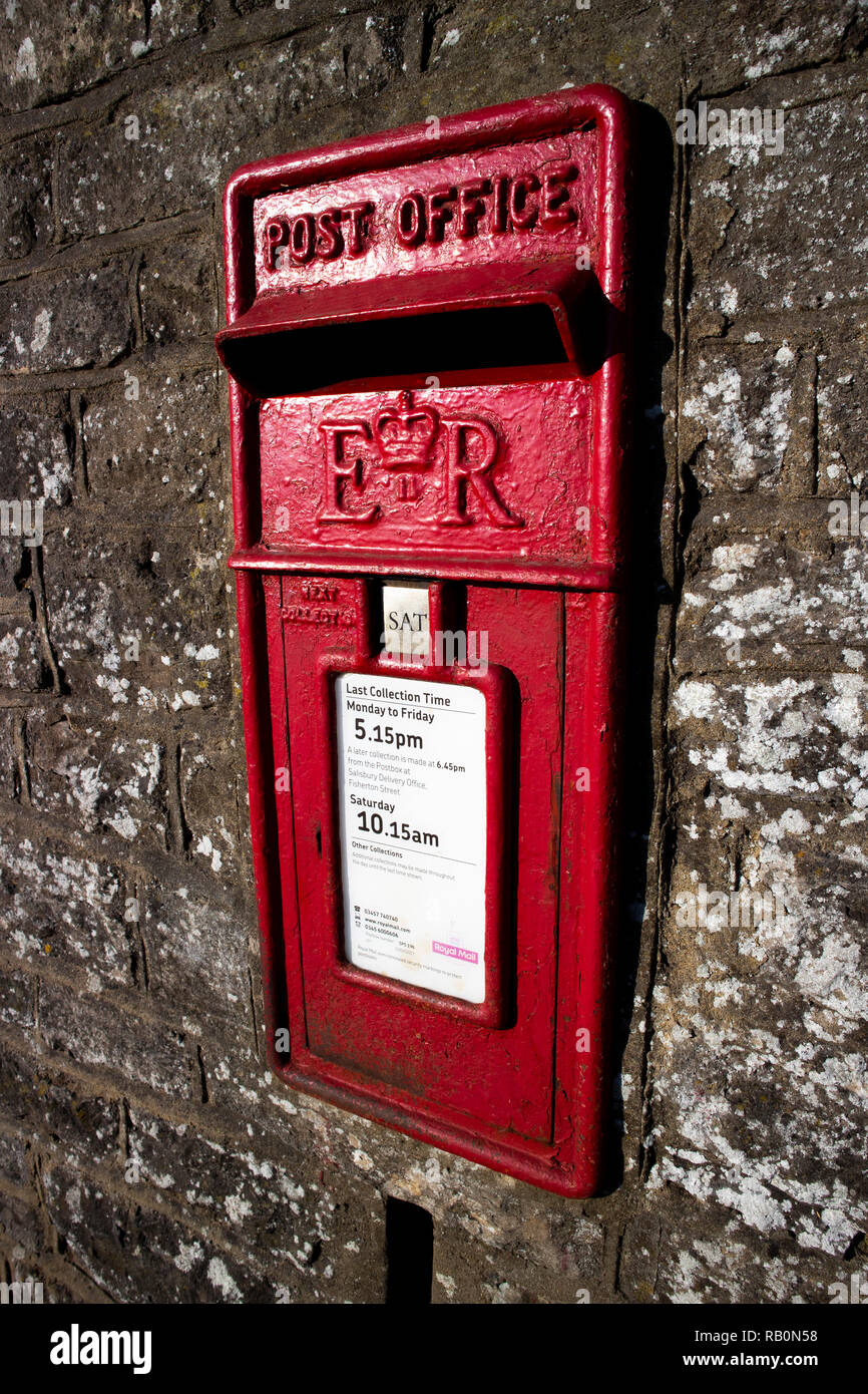 Queen Elizabeth era cast iron post box set into stone retaining wall ...
