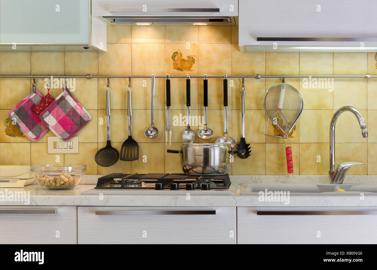 Front view of a modern white kitchen with a pot on the stove Stock ...