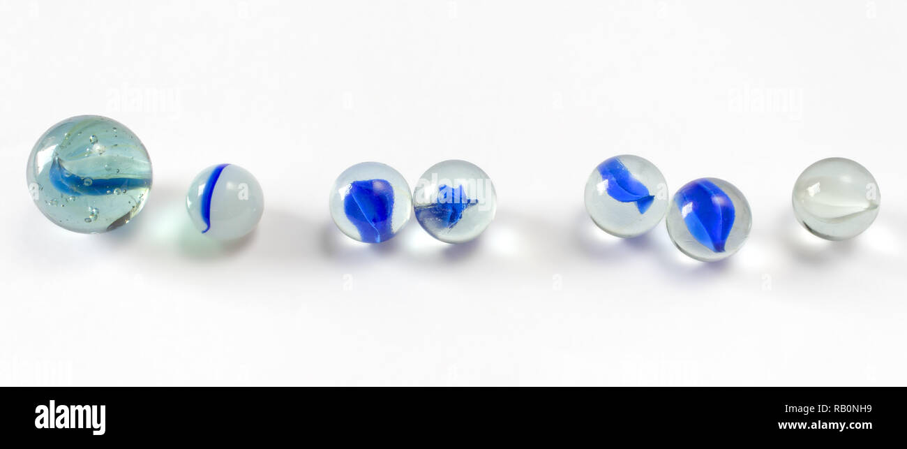 Seven blue transparent marbles on a white background Stock Photo - Alamy