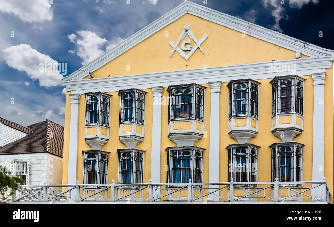 An old plaster Yellow Mason Building in Nassau Bahamas Stock Photo - Alamy