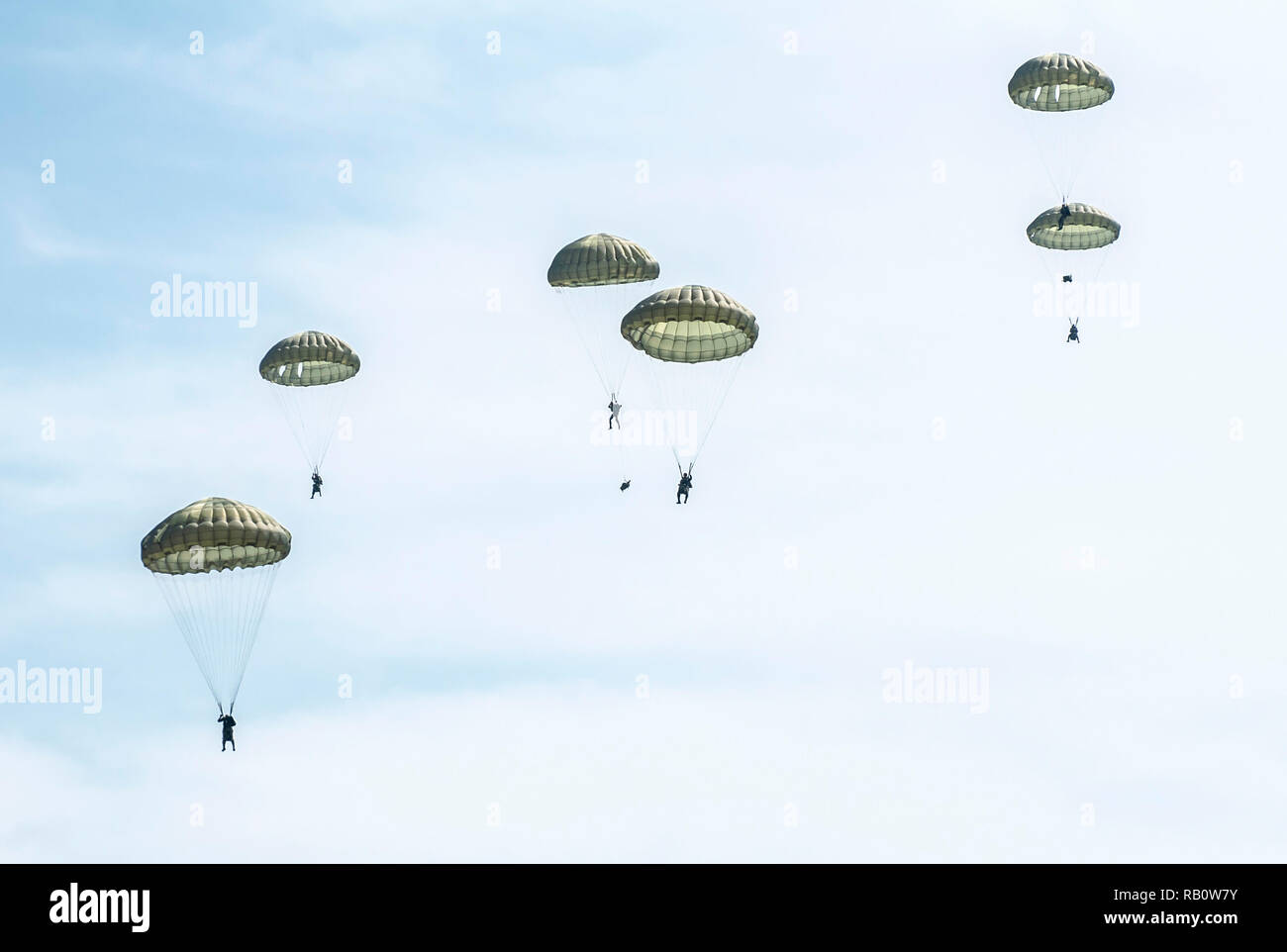 Parachutists jump from a military plane during a military exercise ...