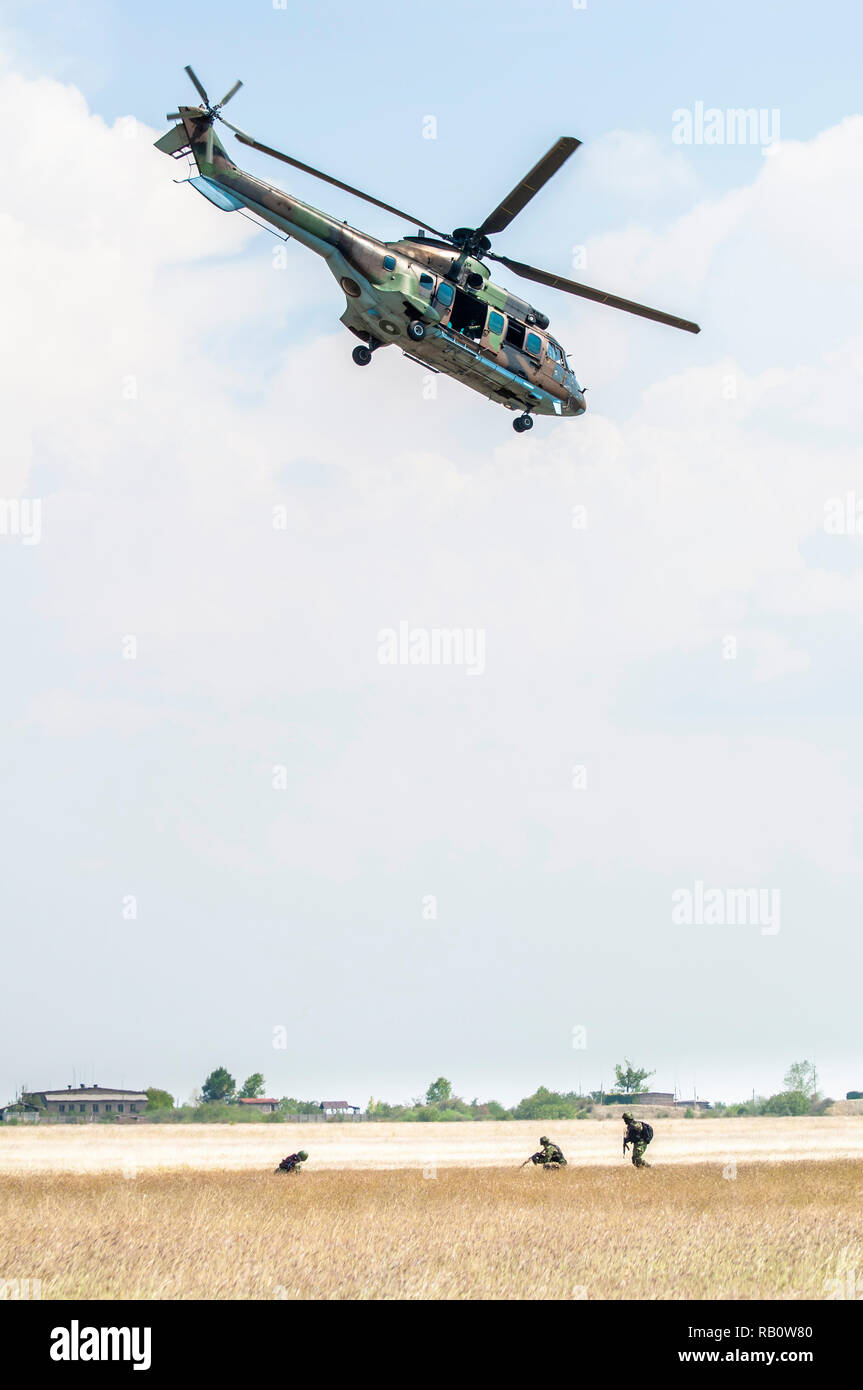 Soldiers on a rescue military operation with helicopter. War and ...