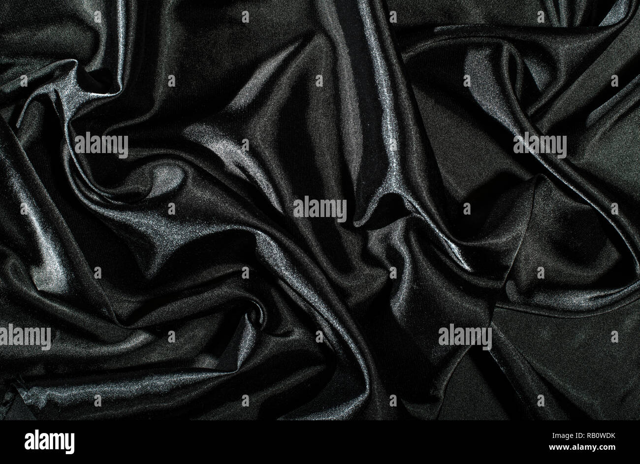 Background of black satin fabric. Shiny silk backdrop Stock Photo - Alamy