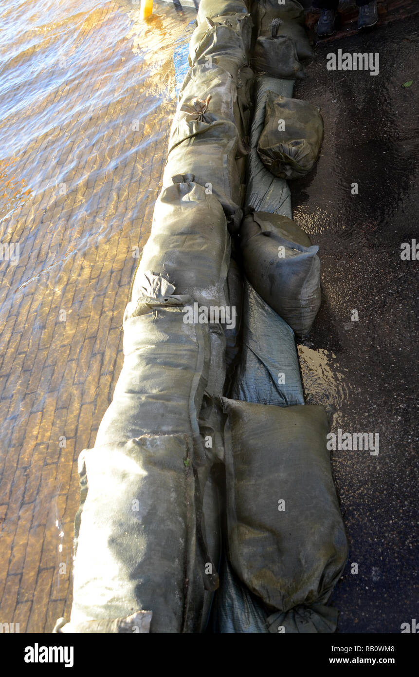 Sandbags keep the water on one side of a temporary embankment Stock ...