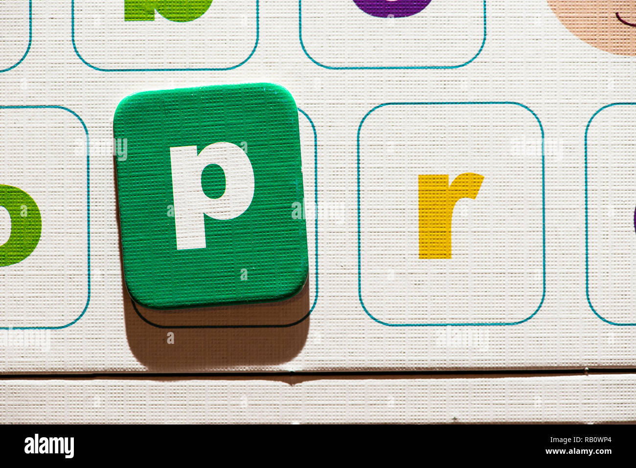 PR letters on cardboard. Colored Characters P and R on white paper ...