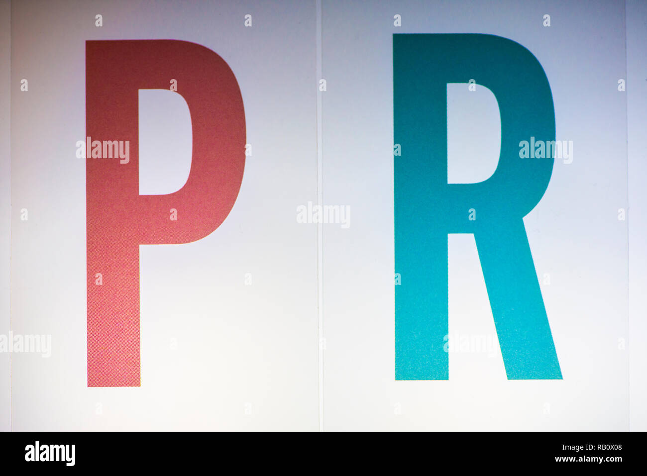 PR letters on backlight board. Colored Characters P and R on white ...