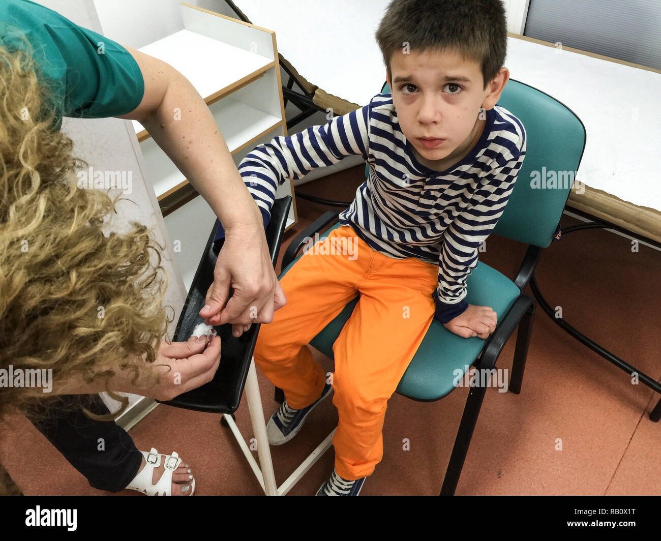 Child in hospital for blood test. Taking blood sample from child’s ...