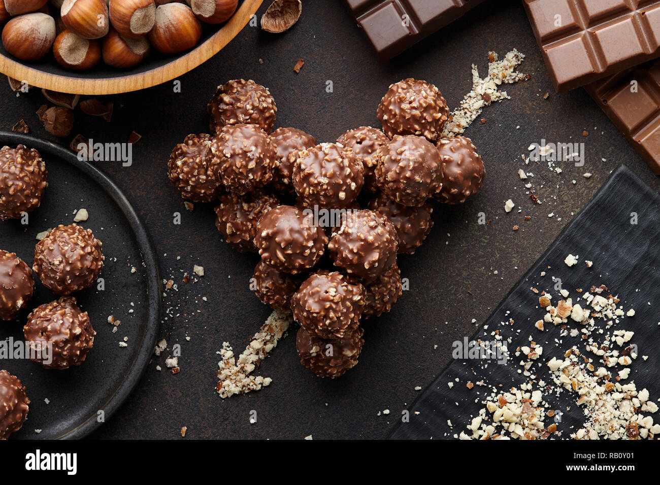 Heart shape with arrow made from chocolate truffle candies with ...