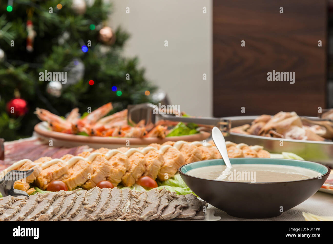 Christmas food prepared in an abundant buffet, chopped meat, a sauce ...