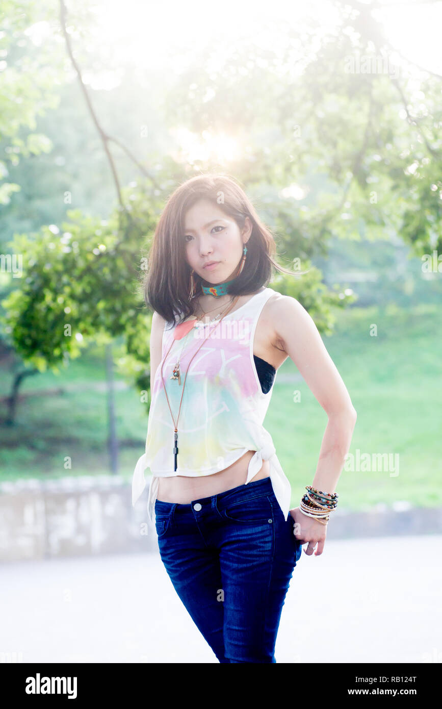 Asian female model poses for pictures on the street Stock Photo - Alamy
