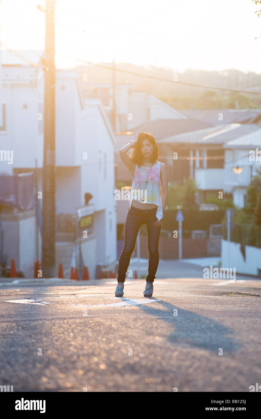 Asian female model poses for pictures on the street Stock Photo - Alamy