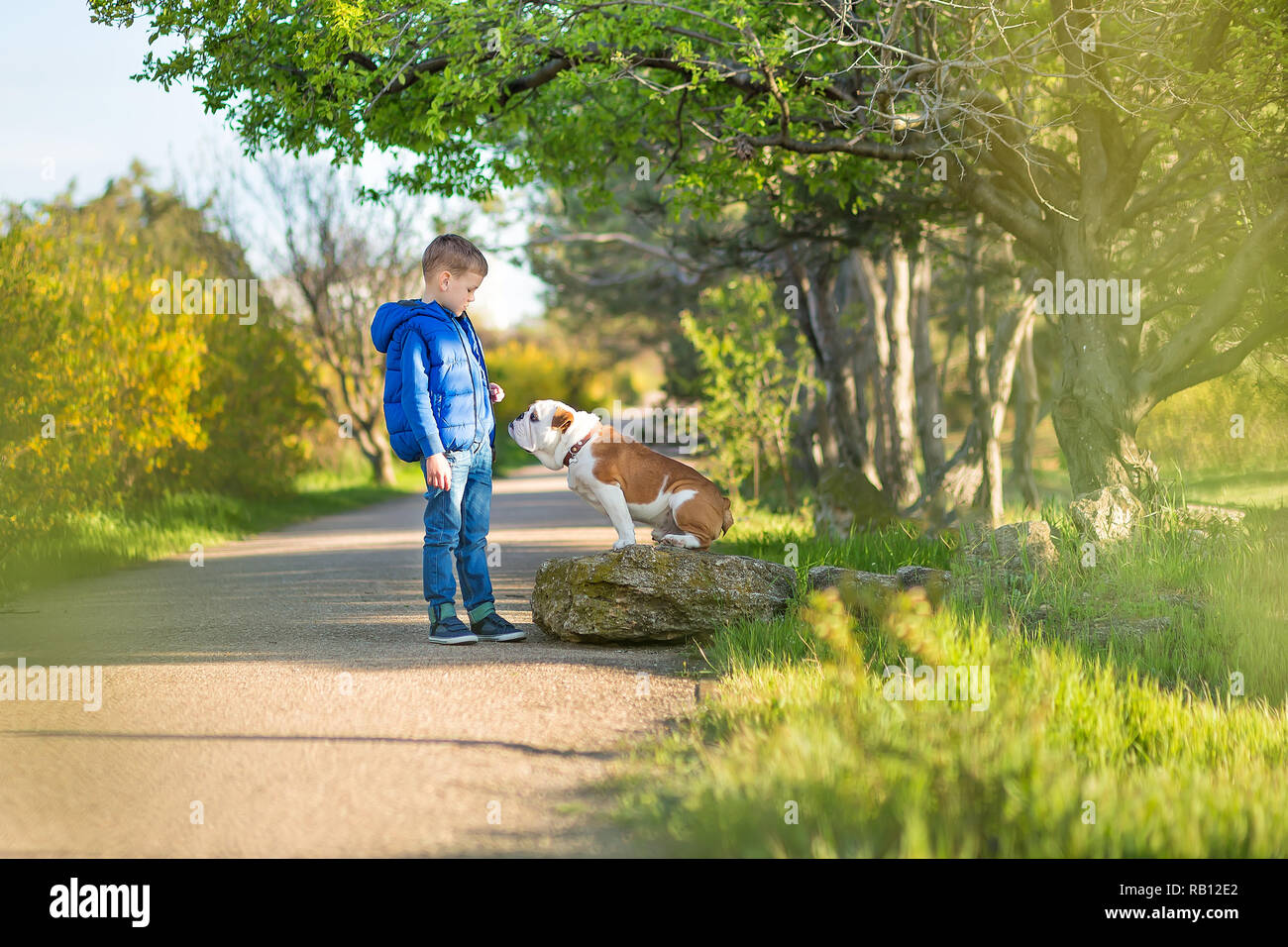 Cute handsome stylish boy enjoying colourful autumn park with his best ...