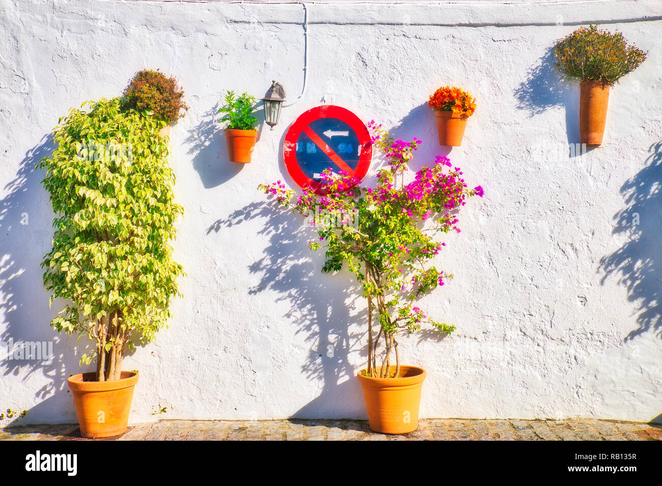 White wall with pots and a road sign in Vejer de la Frontera, Spain ...