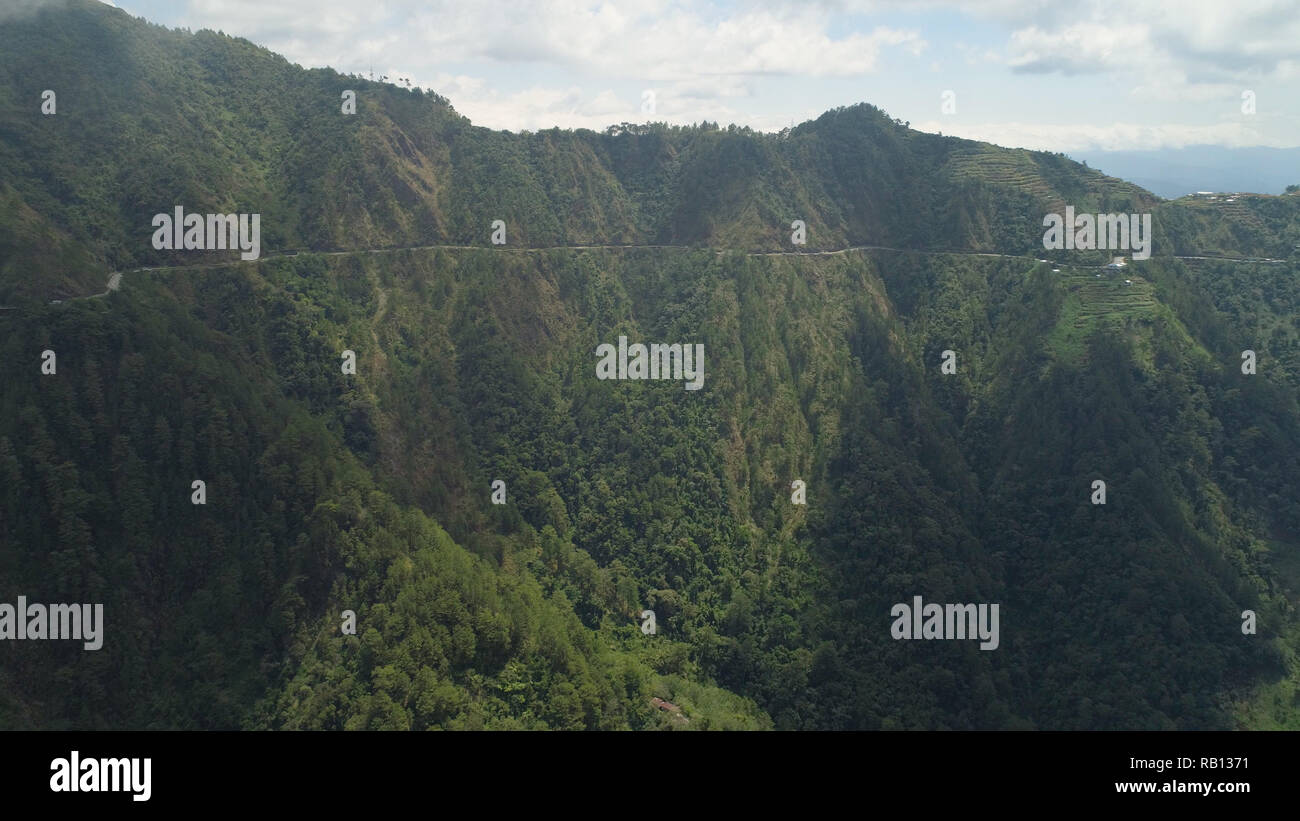 Aerial view of mountains covered forest, trees in clouds. Cordillera ...