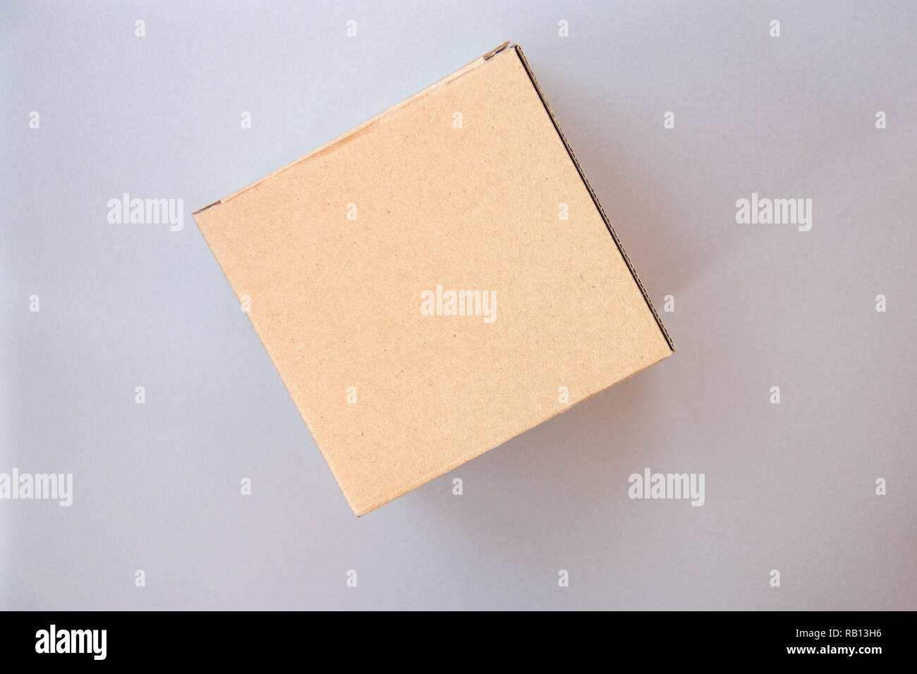 Closed big square cardboard craft gift box on the silver gray metal ...